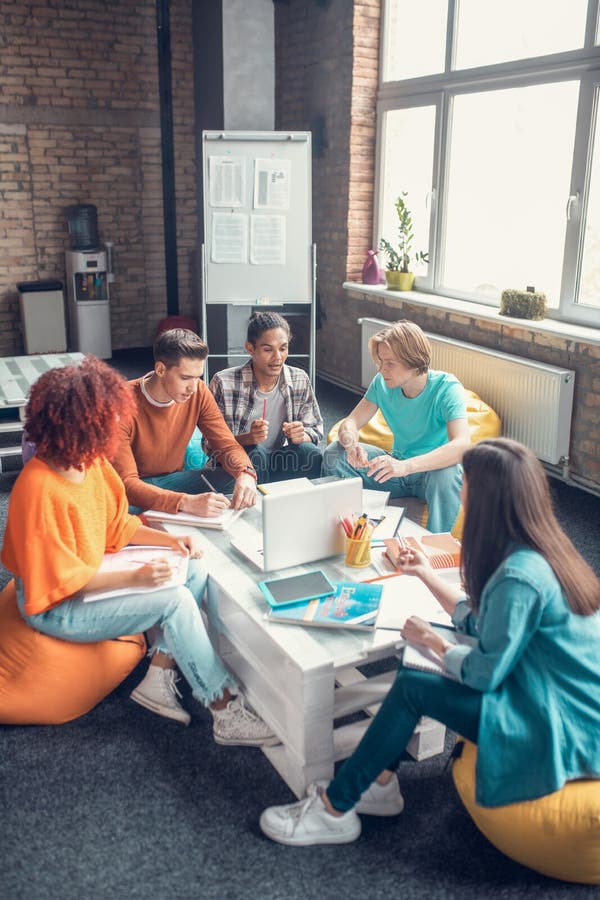 Students Sitting at the Table and Preparing for Group Presentation ...