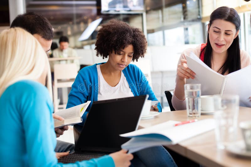 Girls Students Drinking Coffee and Studying Together at Table Stock ...