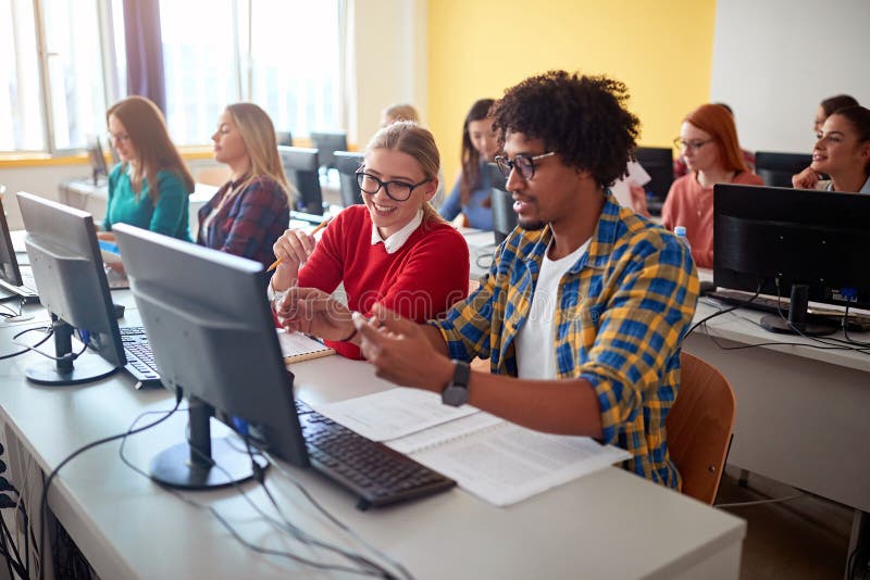 Students Sitting Together at Table Using Computer in Class on ...