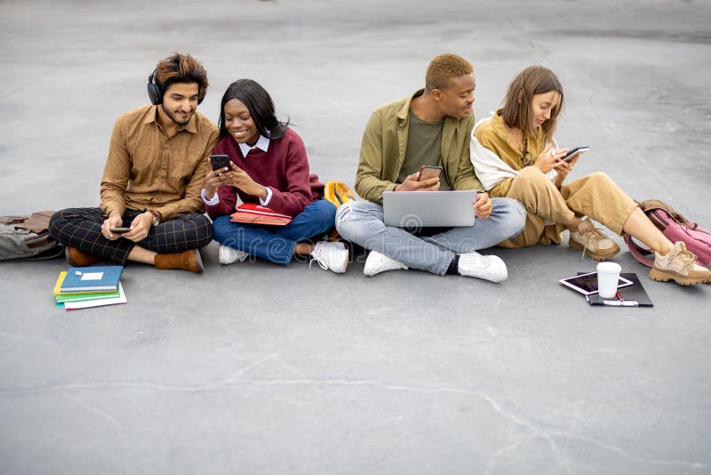 Students Sitting and Using Smartphones on Asphalt Stock Photo - Image ...