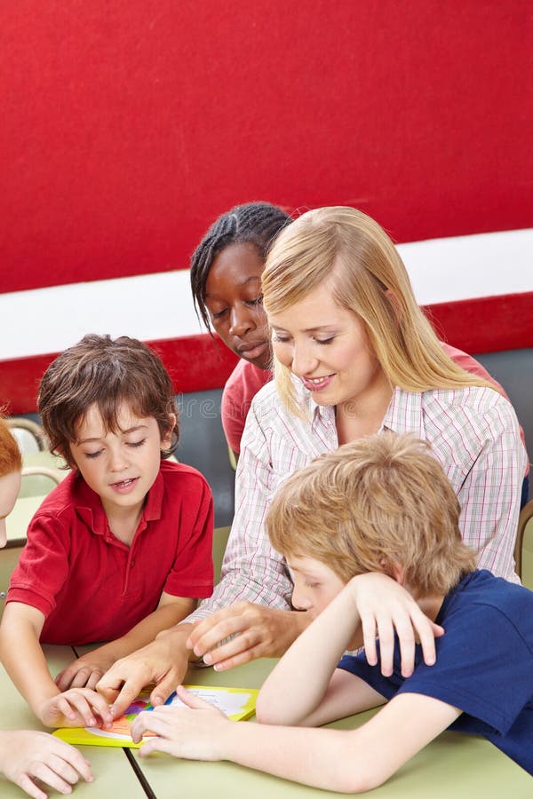 Students Solve Puzzle with Teacher at School Stock Image - Image of ...