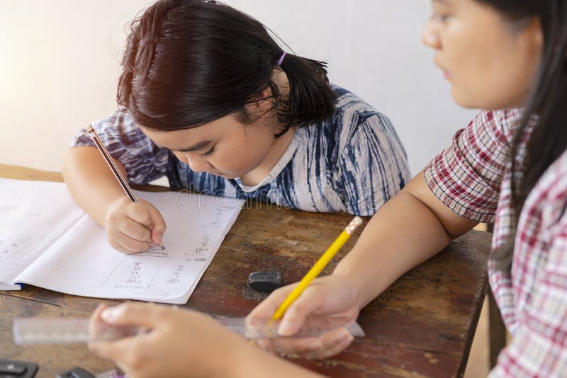 Students are Solving Mathematical Problems Concept. the Teacher is ...