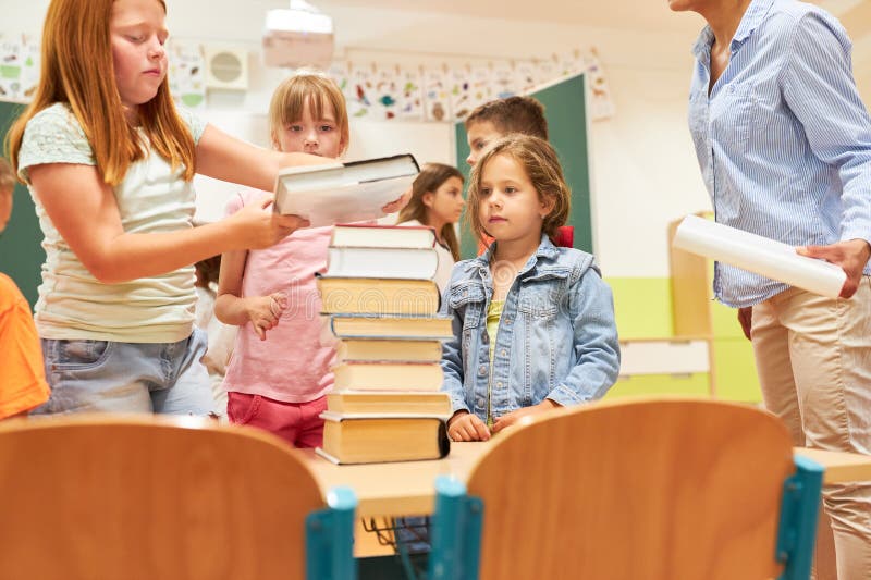 Students Stacking Books during Activity at School Stock Image - Image ...