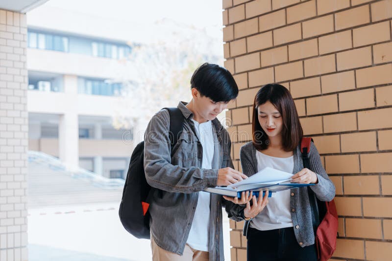 Students Stand To Read a Book Together on the Campus. Education Concept ...