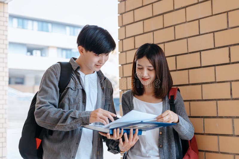 Students Stand To Read a Book Together on the Campus. Education Concept ...