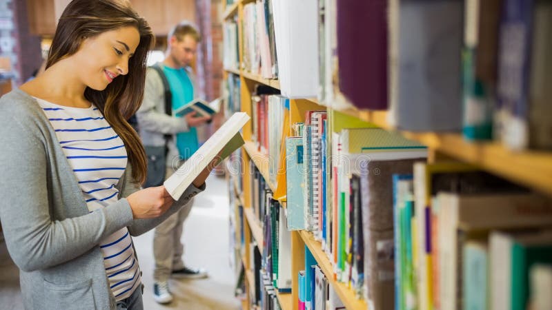 Students Standing by Bookshelf in the Library Stock Image - Image of ...