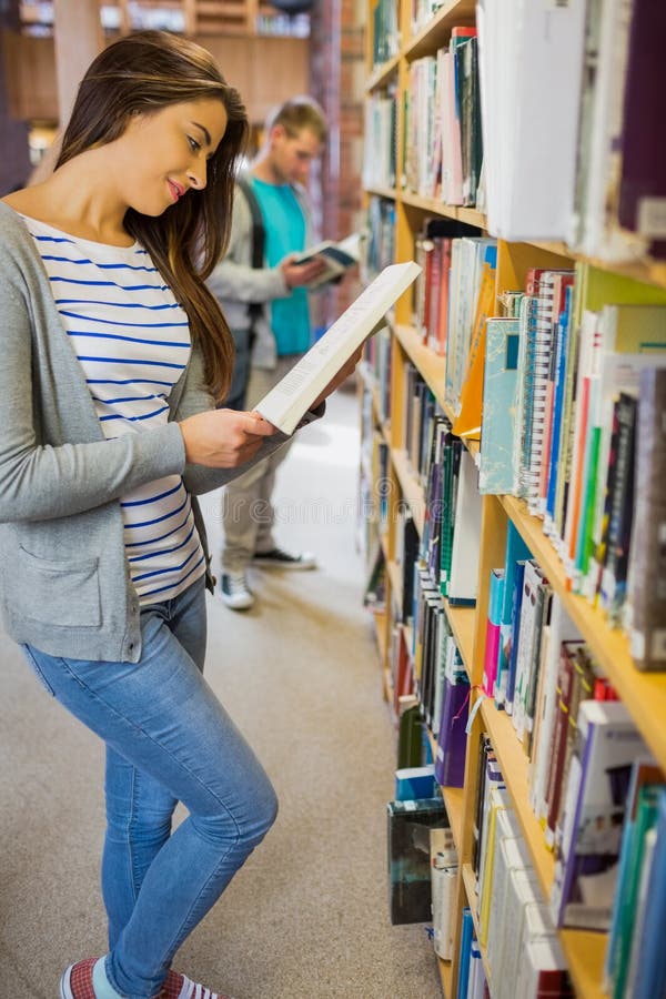 Students Standing by Bookshelf in the Library Stock Photo - Image of ...