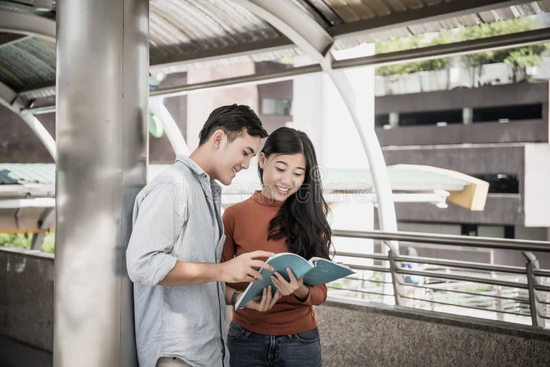 Students Standing Reading Books Together on the Way Stock Image - Image ...