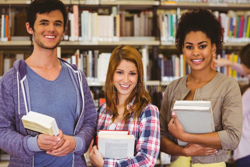 Students Standing and Smiling at Camera Holding Books Stock Photo ...