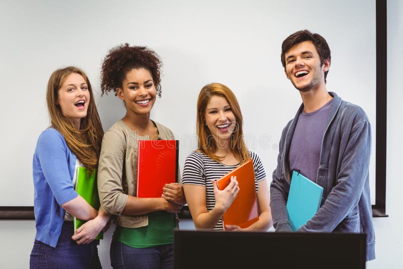 Students Standing and Smiling at Camera Holding Notepads Stock Photo ...