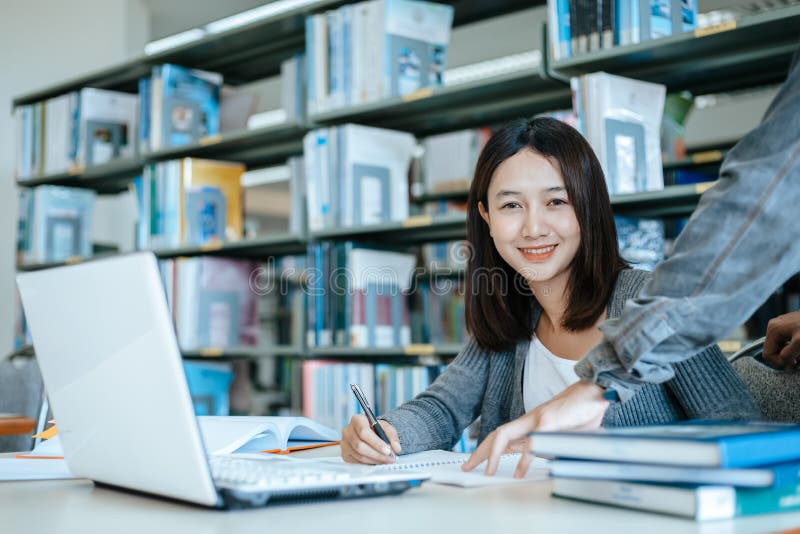 Students Studying in the Library with Laptop at the University ...