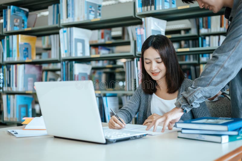 Students Studying in the Library with Laptop at the University ...