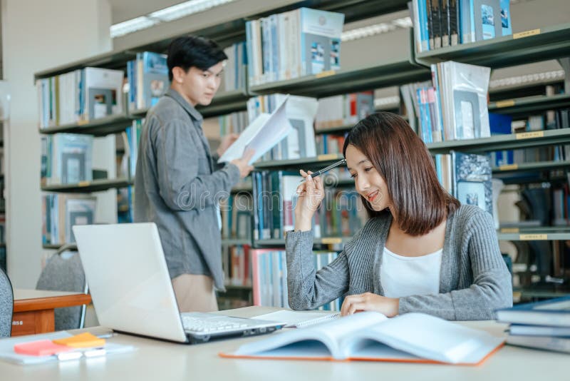 Students Studying in the Library with Laptop at the University ...