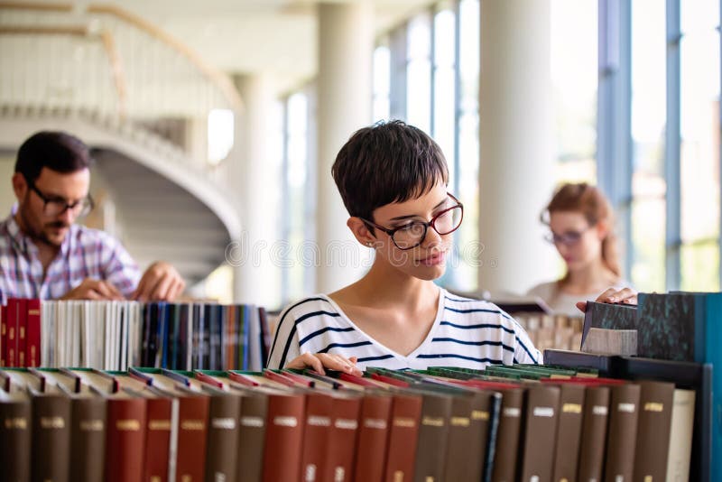 Students Studying in Library. Young Success People are Spending Time ...