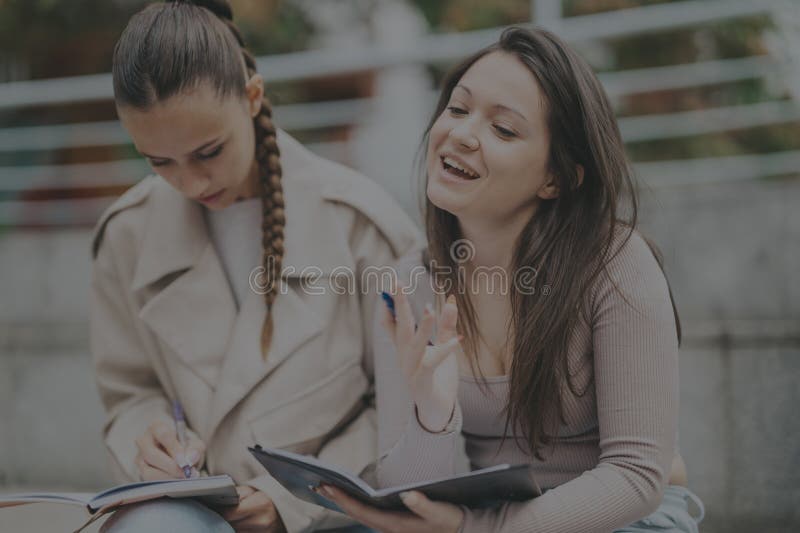 Students Studying Together Outdoors in a Bustling City Environment ...