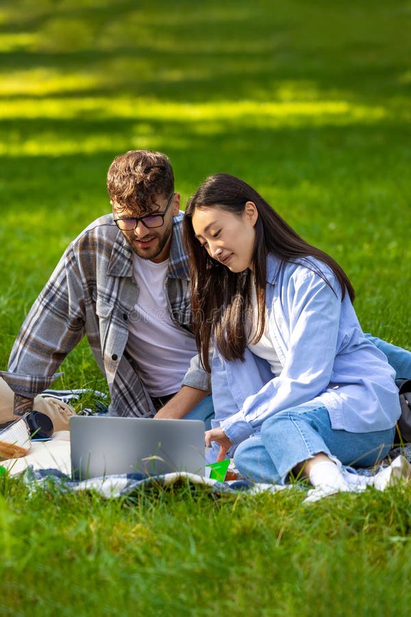 Students Studying Together Outdoors on a Green Lawn Stock Photo - Image ...