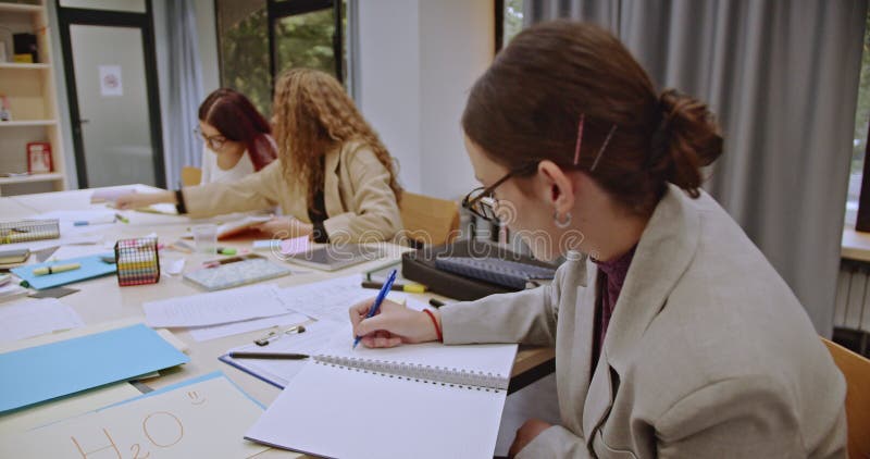 Students Taking Exam after Class with Teacher in Classroom Stock Video ...