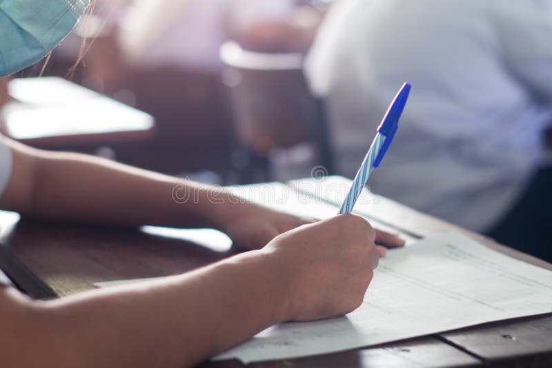 Students Taking Exam and Writing Answer in Classroom with Wear Face ...