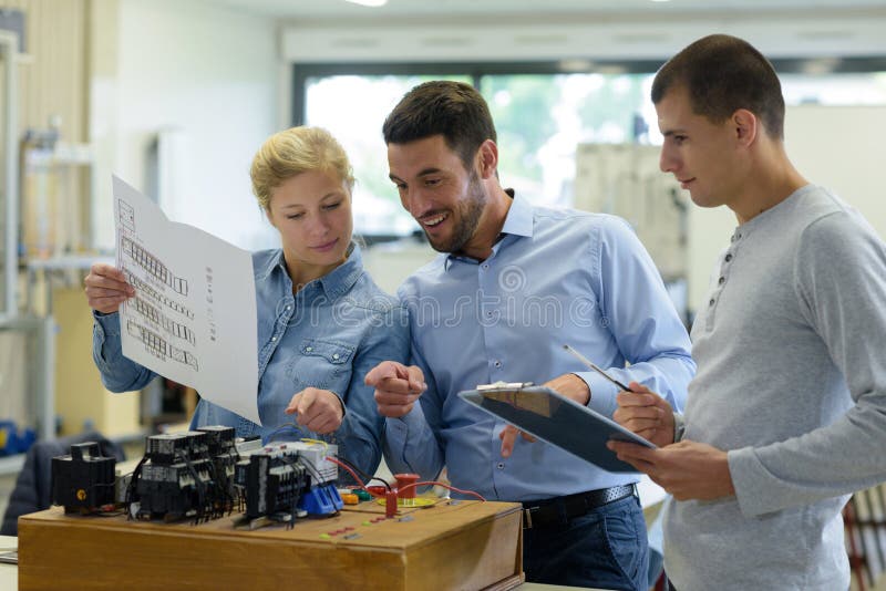 Students Taking Notes in Engineering Laboratory with Teacher Stock ...