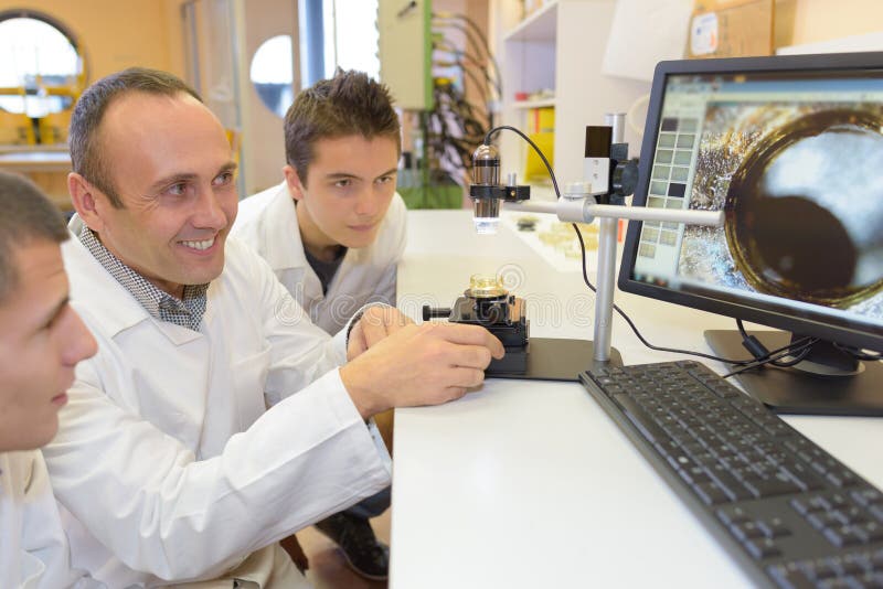 Students and Teacher Looking at Magnified Image on Computer Screen ...