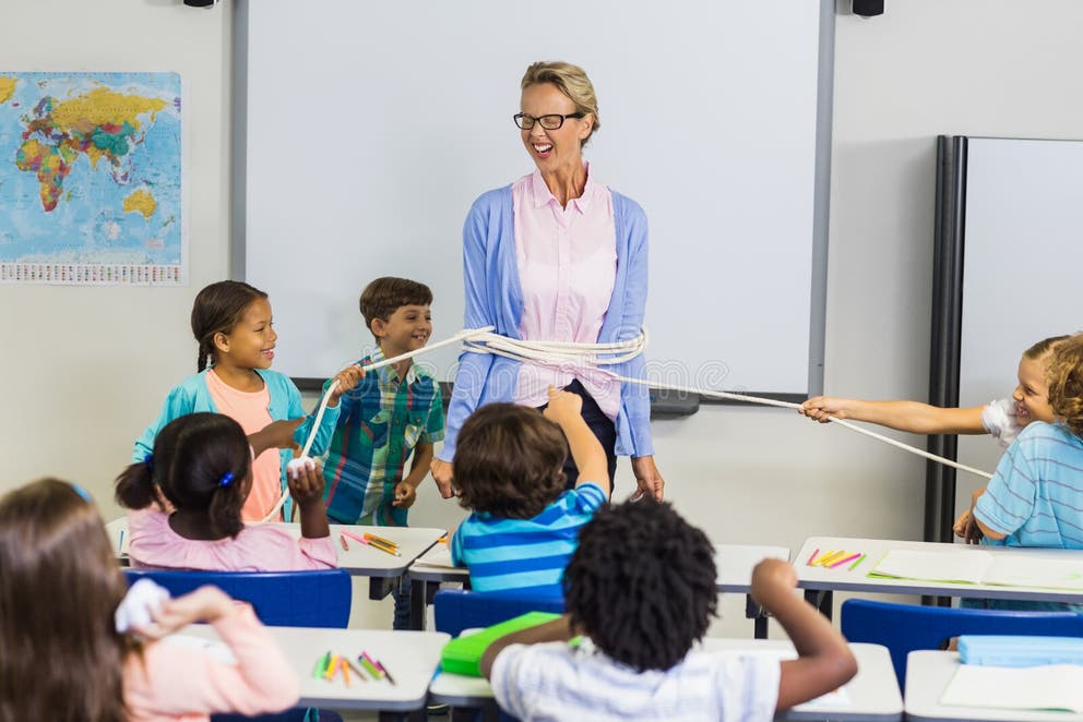 Students Tying Up a Teacher with Rope in Classroom Stock Photo - Image ...