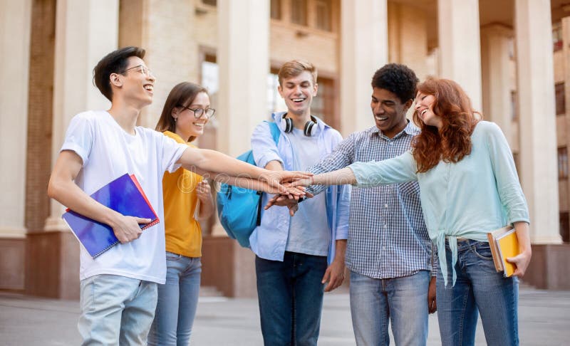 Students Holding Hands Standing in Circle Outside University Building ...