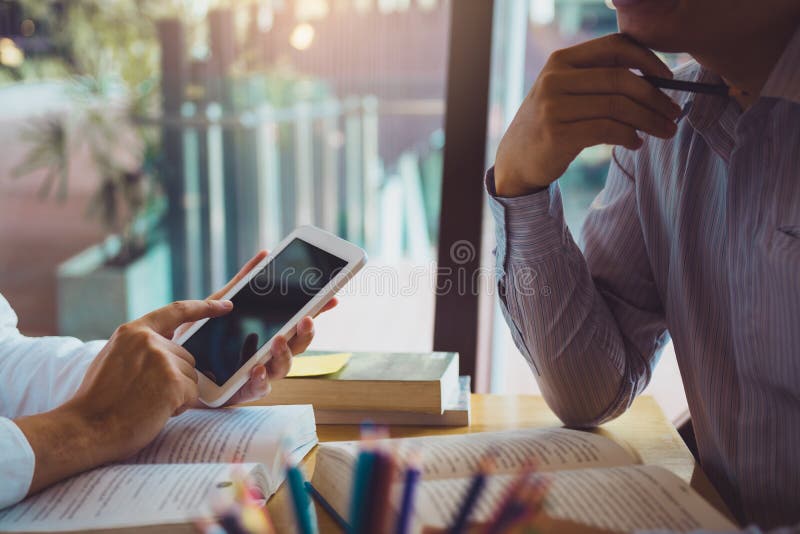 Students Use the Tablet To Search for Students` Homework for Their ...