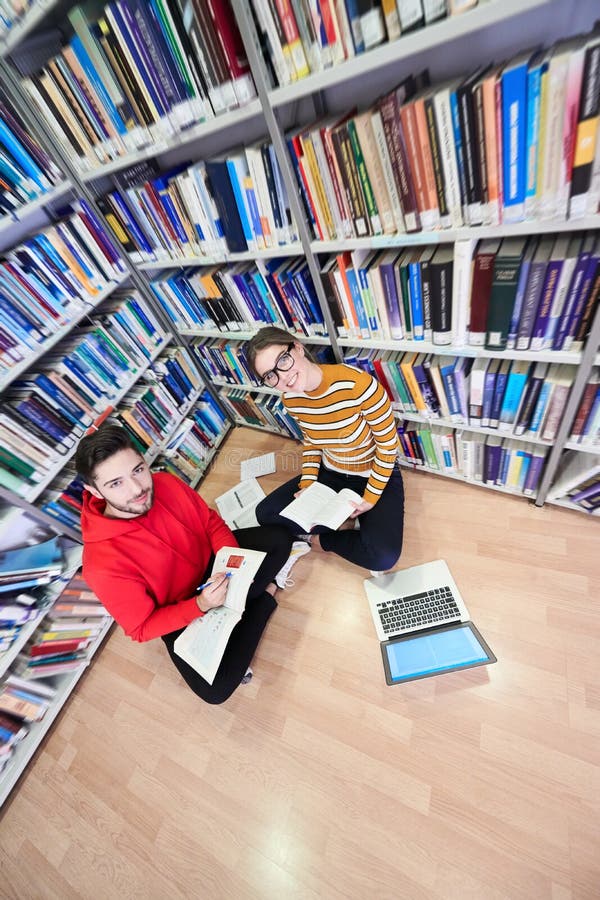 The Students Uses a Notebook, Laptop and a School Library Stock Image ...
