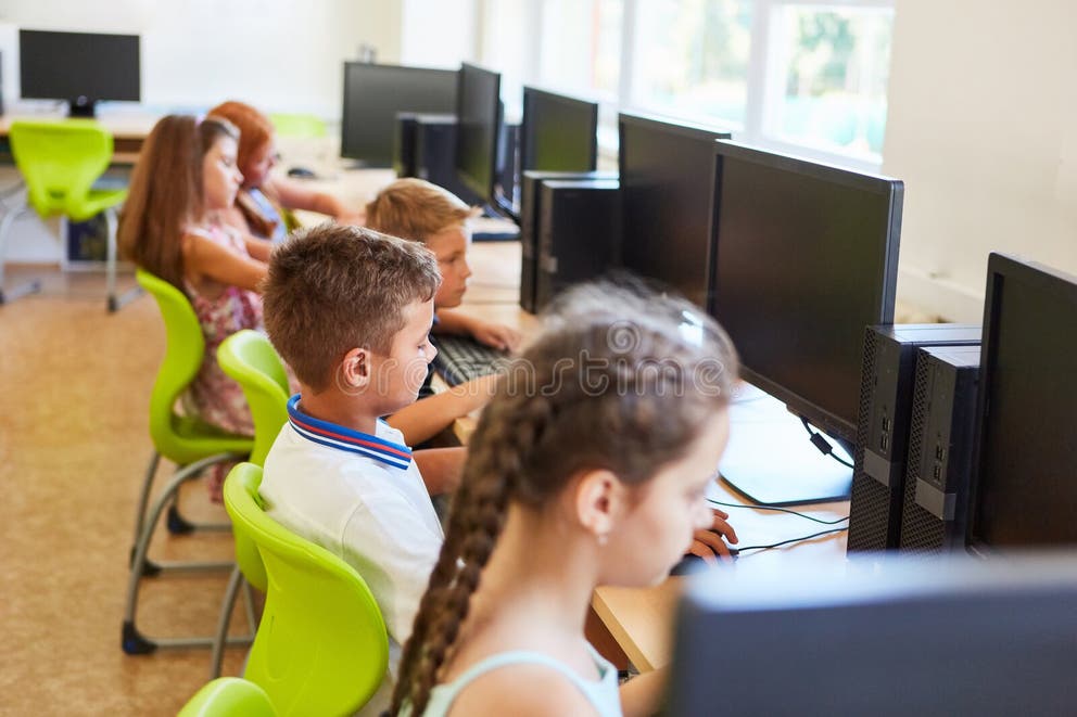 Students Using Computers Sitting at Desk in School Stock Image - Image ...