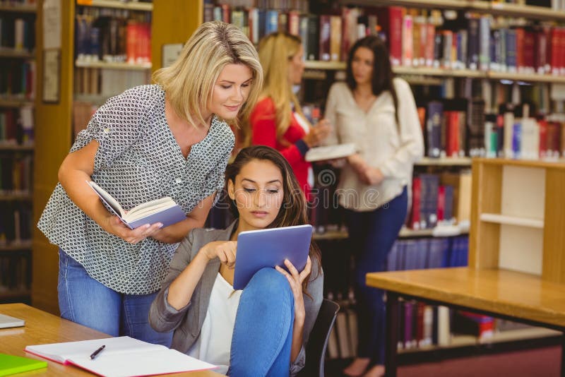 Students Using a Digital Tablet with Classmates Behind Stock Image ...