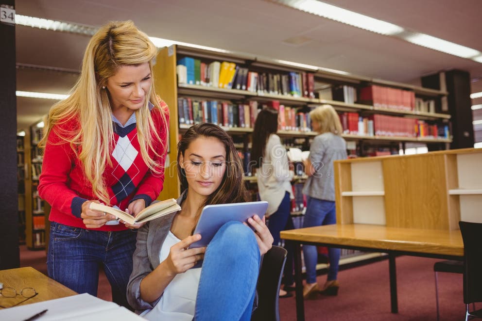Students Using a Digital Tablet with Classmates Behind Stock Image ...