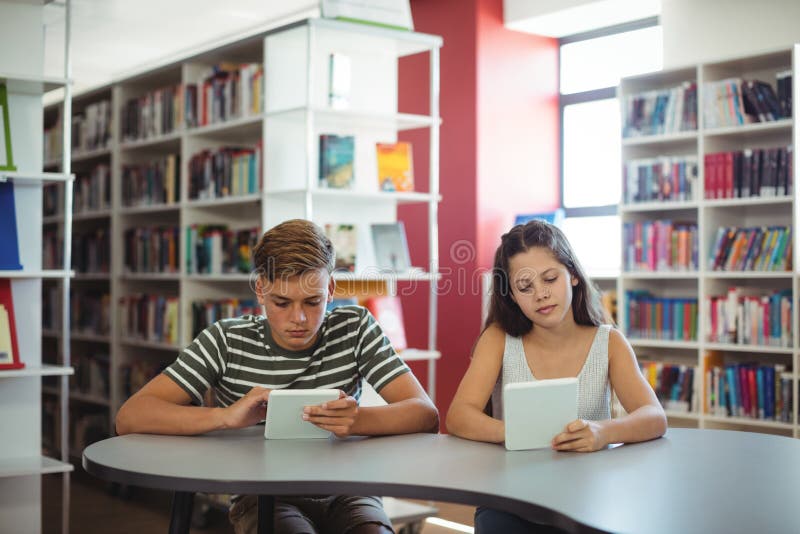 Students Using Digital Tablet in Library Stock Image - Image of ...