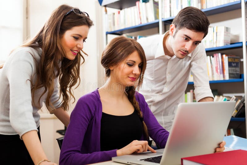 Students Using a Laptop in a Library Stock Image - Image of girl ...