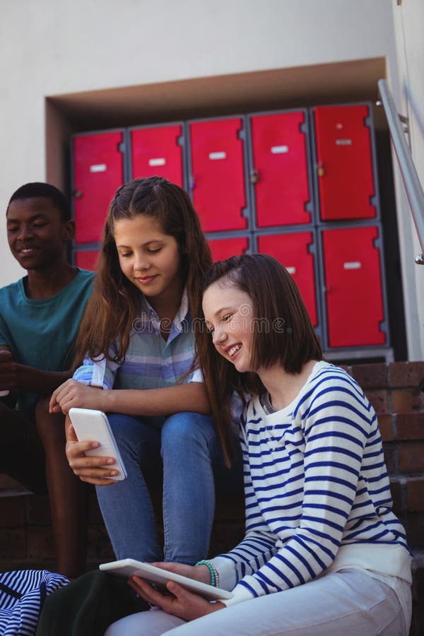 Students Using Mobile Phone and Digital Tablet on Staircase Stock Image ...