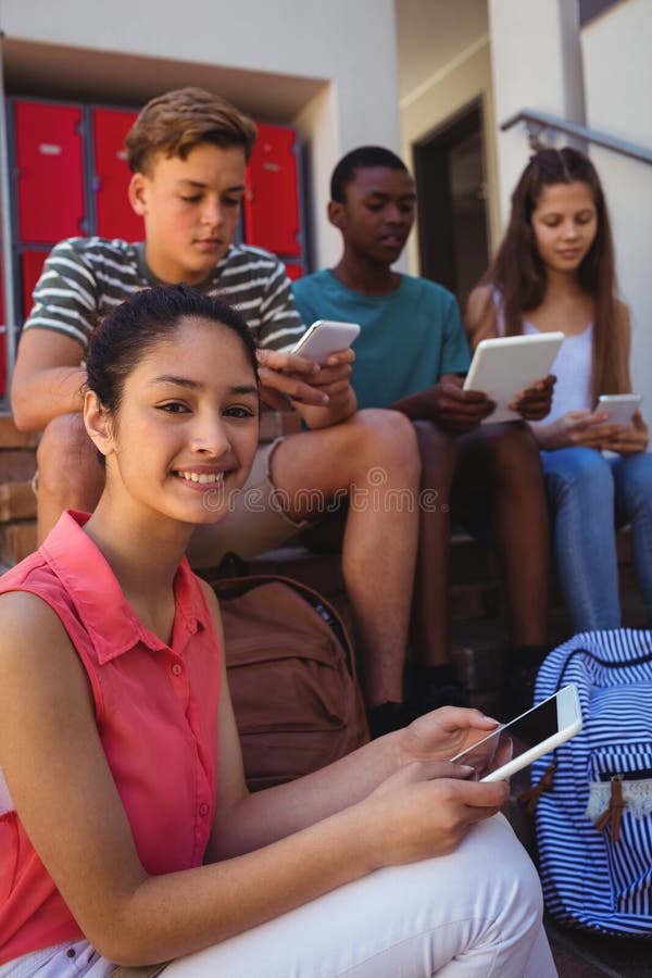Students Using Mobile Phone and Digital Tablet on Staircase Stock Photo ...