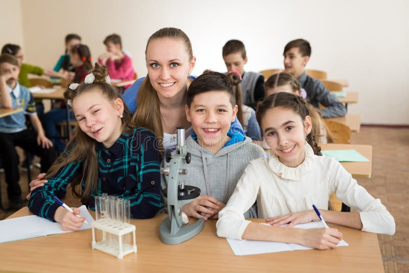 Students Using Science Beakers and a Microscope at the Elementary ...
