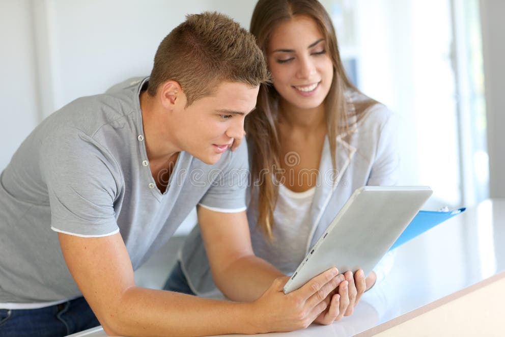 Students using tablet stock image. Image of goodlooking - 26497671
