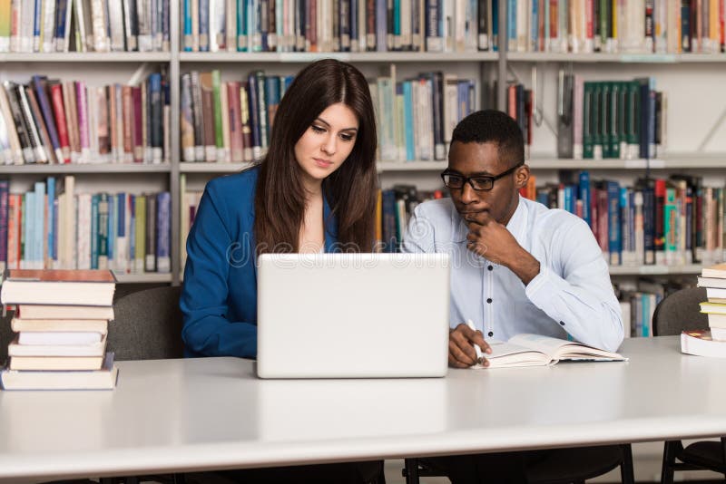 Students Using a Tablet Computer in a Library Stock Photo - Image of ...
