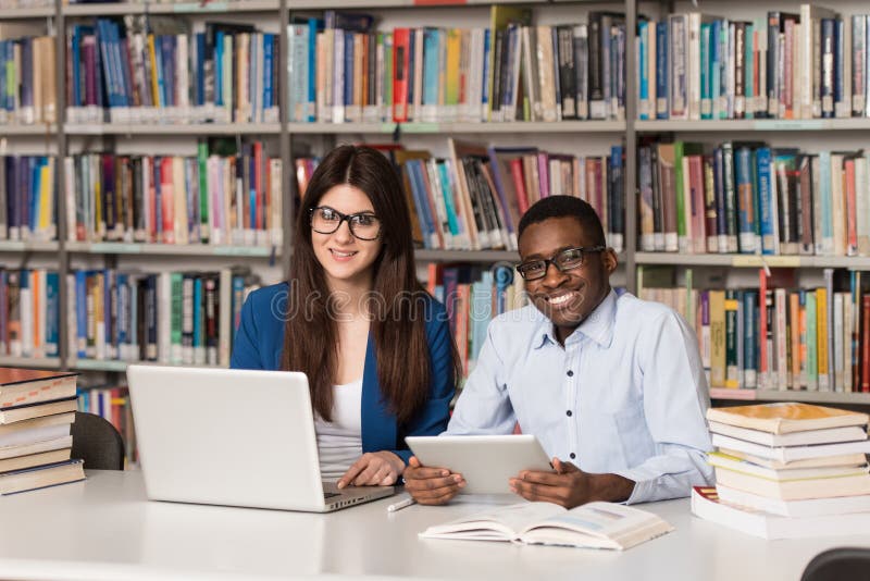 Students Using a Tablet Computer in a Library Stock Photo - Image of ...