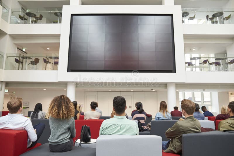 Students Watching Big Screen in University Atrium, Back View Stock ...