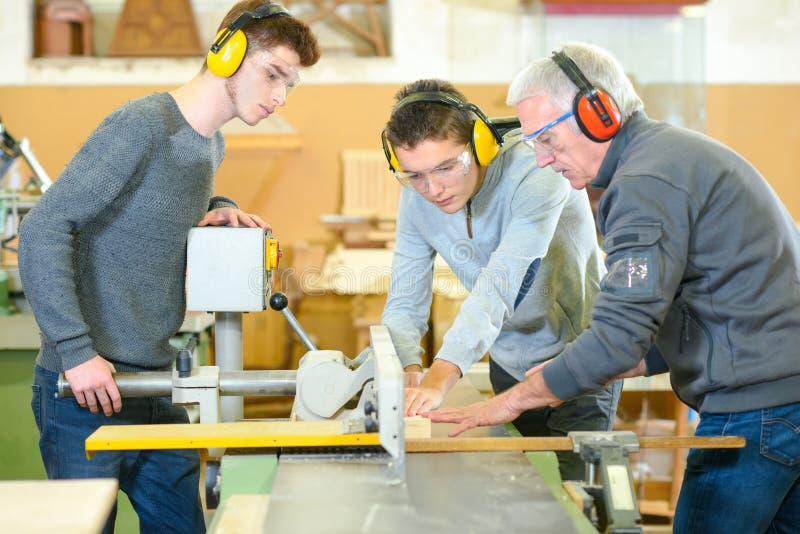Students in woodwork class stock photo. Image of earmuffs - 121238960