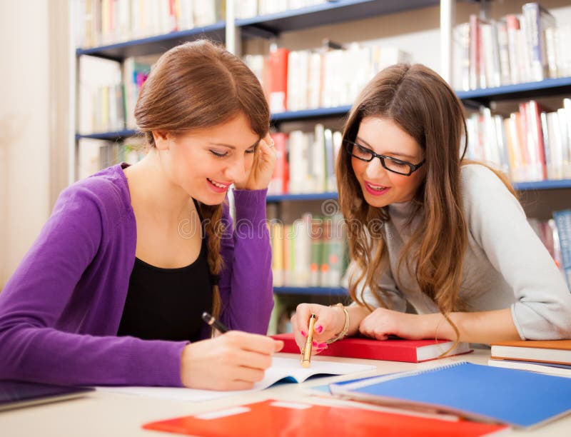 Students at Work in a Library Stock Photo - Image of bookshelf, holding ...