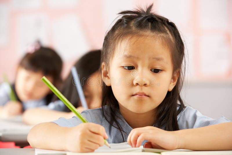 Students Working at Desks in Chinese School Stock Photo - Image of ...