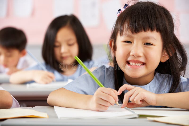 Students Working at Desks in Chinese School Stock Image - Image of desk ...