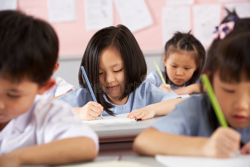 Students Working at Desks in Chinese School Stock Photo - Image of five ...