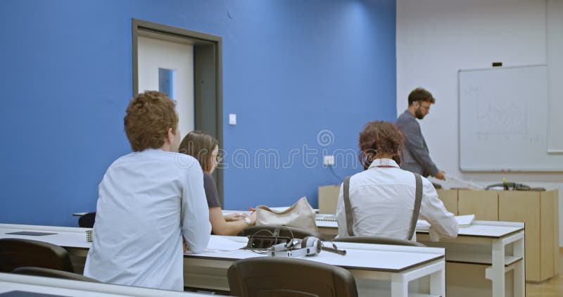Students Working on Individual Tasks or Exam during Class, Professor ...