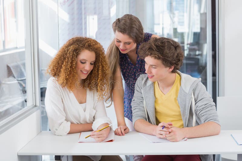 Students Working Together in Class Stock Photo - Image of notebook ...
