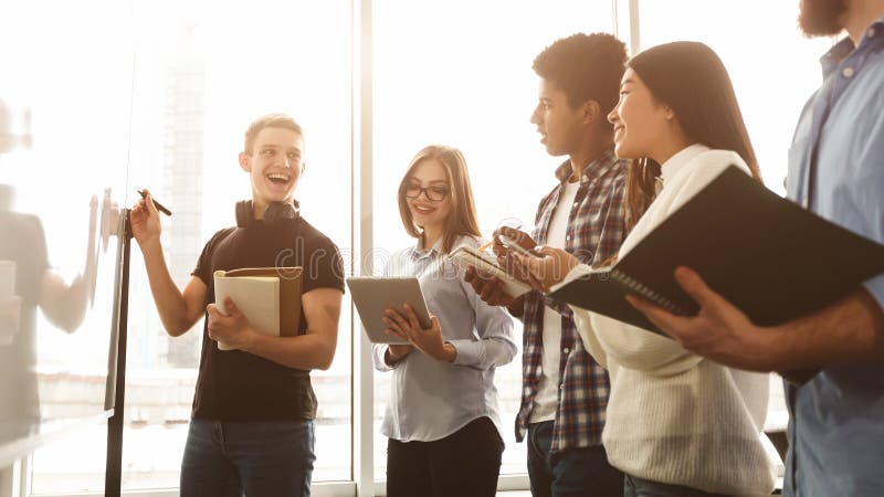 Students Writing Assignments on Whiteboard in Classroom Stock Photo ...