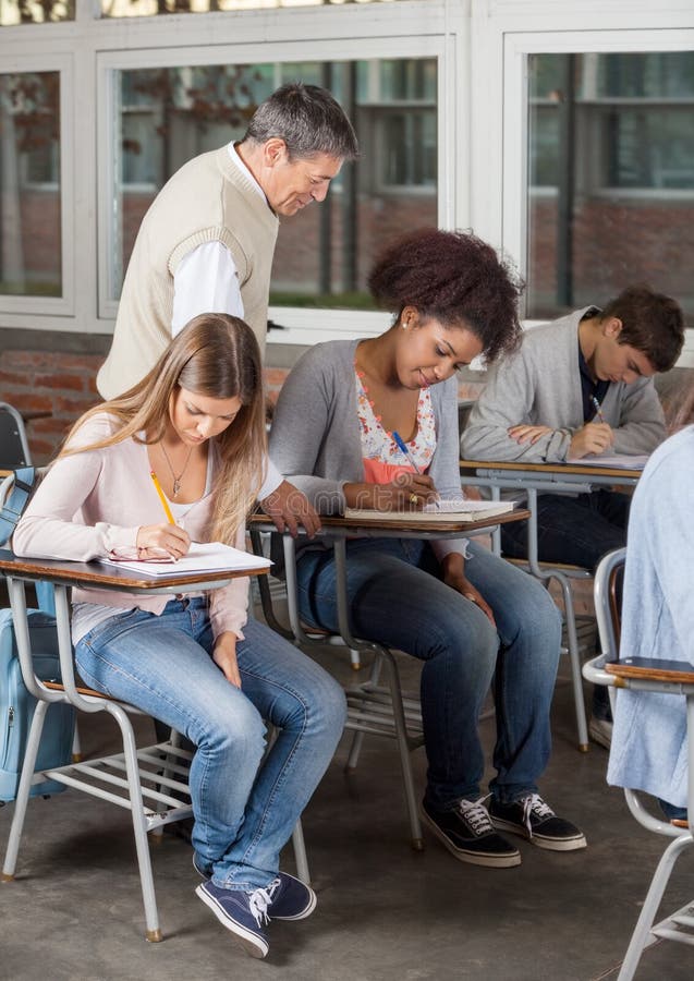 Students Writing Exam while Professor Supervising Stock Photo - Image ...