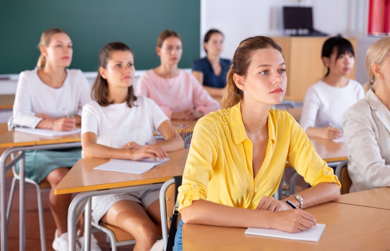 Students Writing in Notepads during Lesson Stock Image - Image of class ...